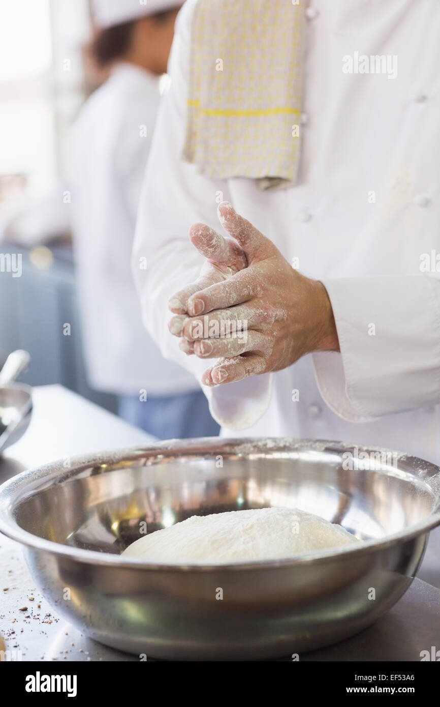 Baker clapping flour from his hands Stock Photo - Alamy