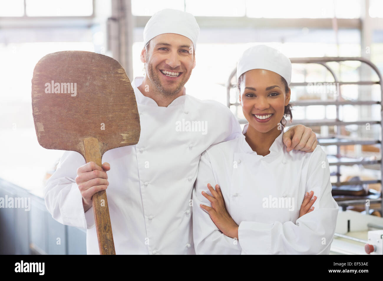 Team of bakers smiling at camera Stock Photo - Alamy