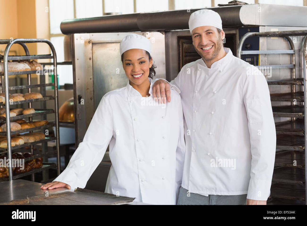 Team of bakers smiling at camera Stock Photo - Alamy