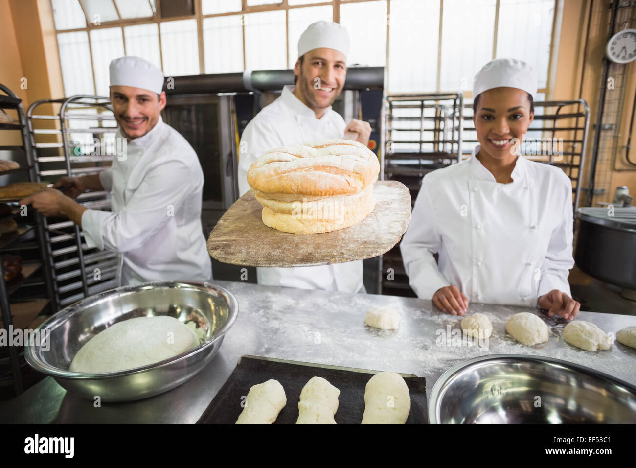 Team of bakers working together Stock Photo - Alamy