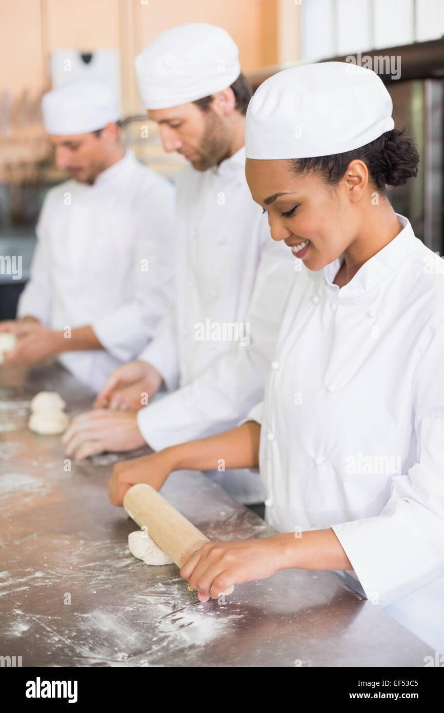 Team of bakers working at counter Stock Photo - Alamy