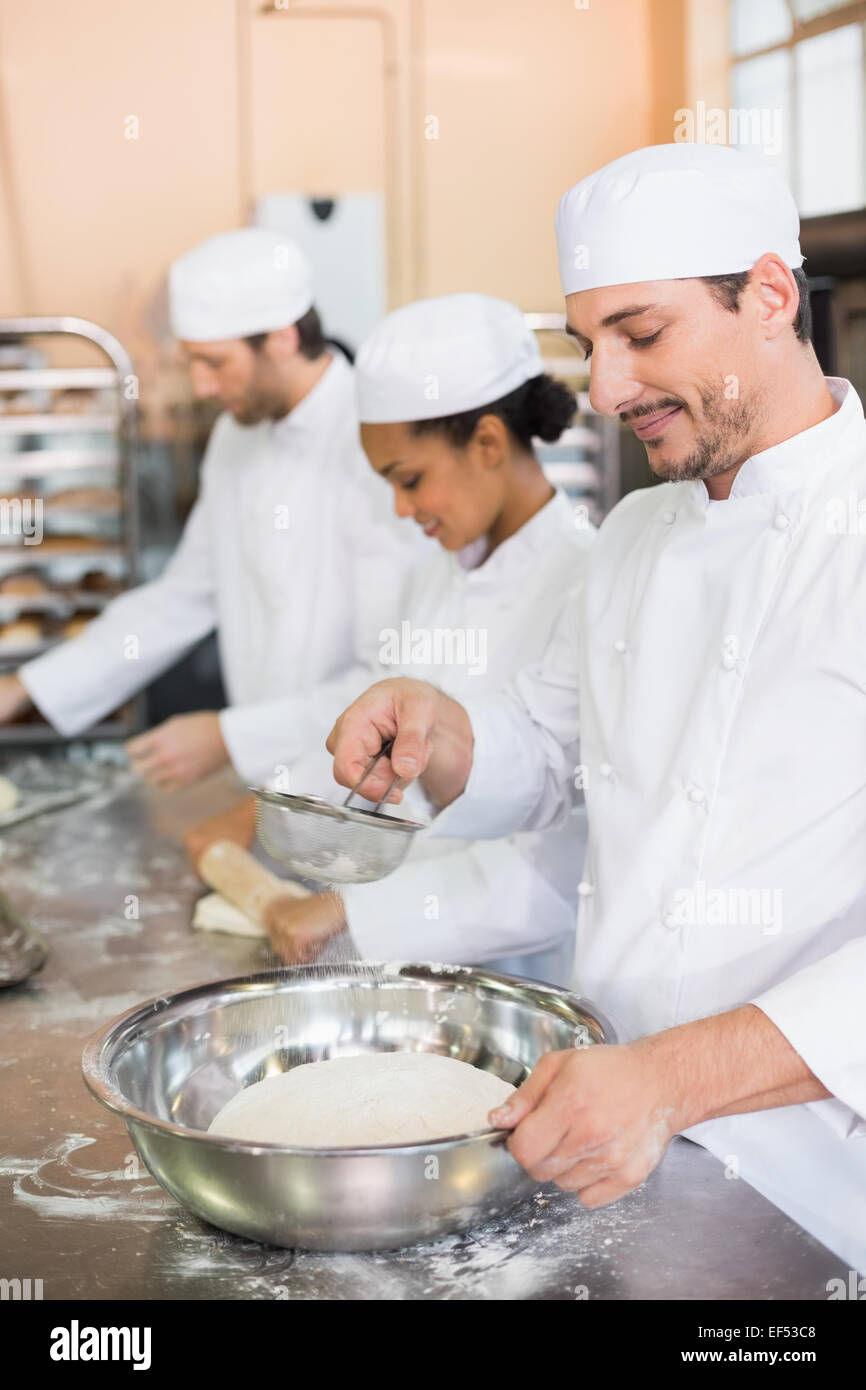 Team of bakers working at counter Stock Photo - Alamy