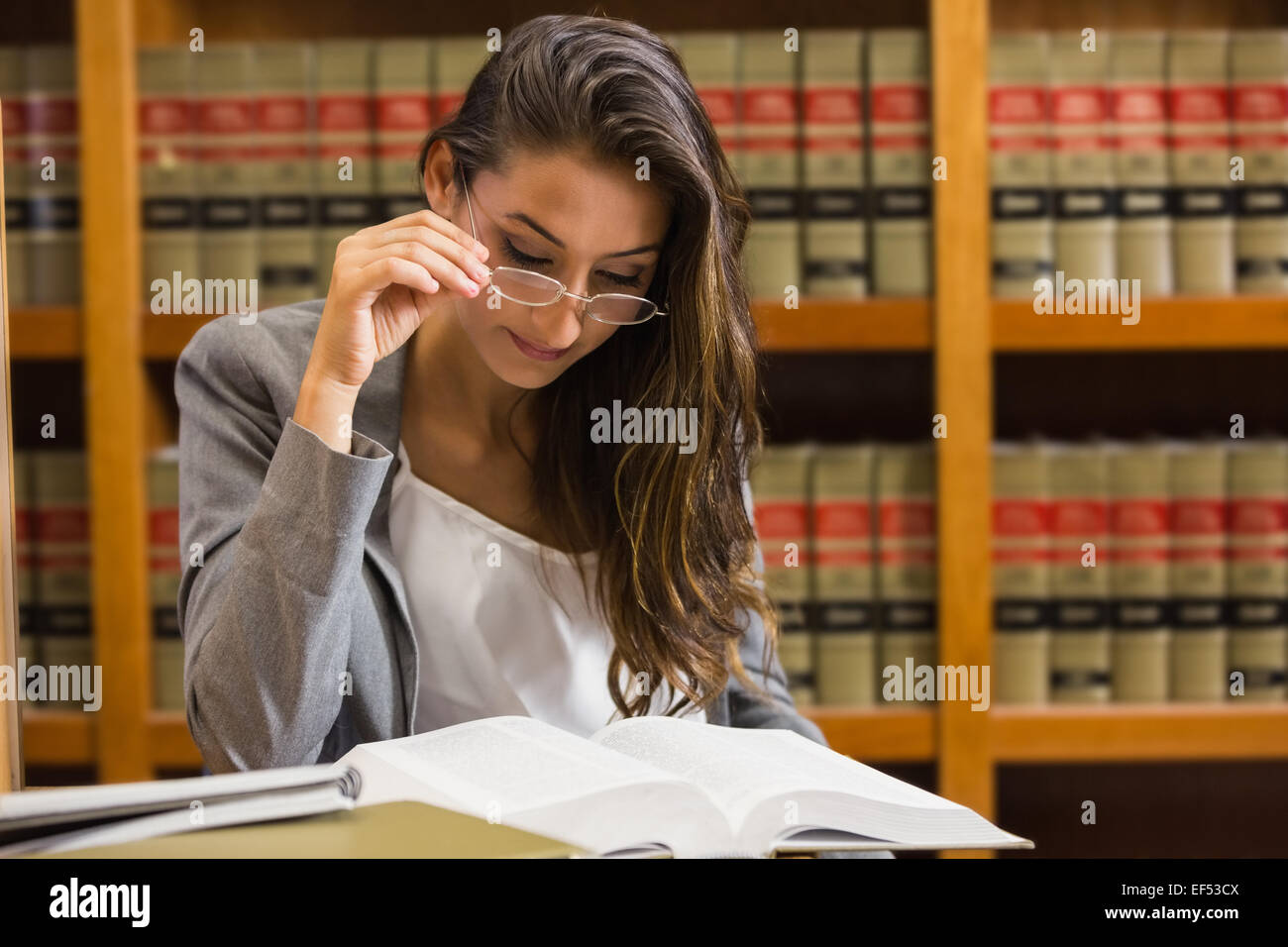 Pretty lawyer in the law library Stock Photo - Alamy