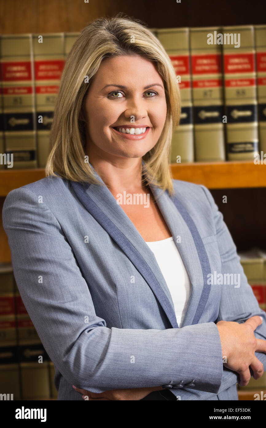 Lawyer smiling at camera in law library Stock Photo - Alamy