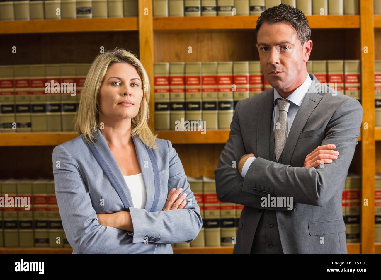 Lawyers looking at camera in the law library Stock Photo - Alamy
