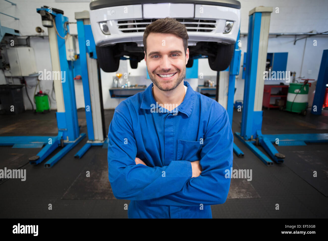 Mechanic smiling at the camera Stock Photo - Alamy
