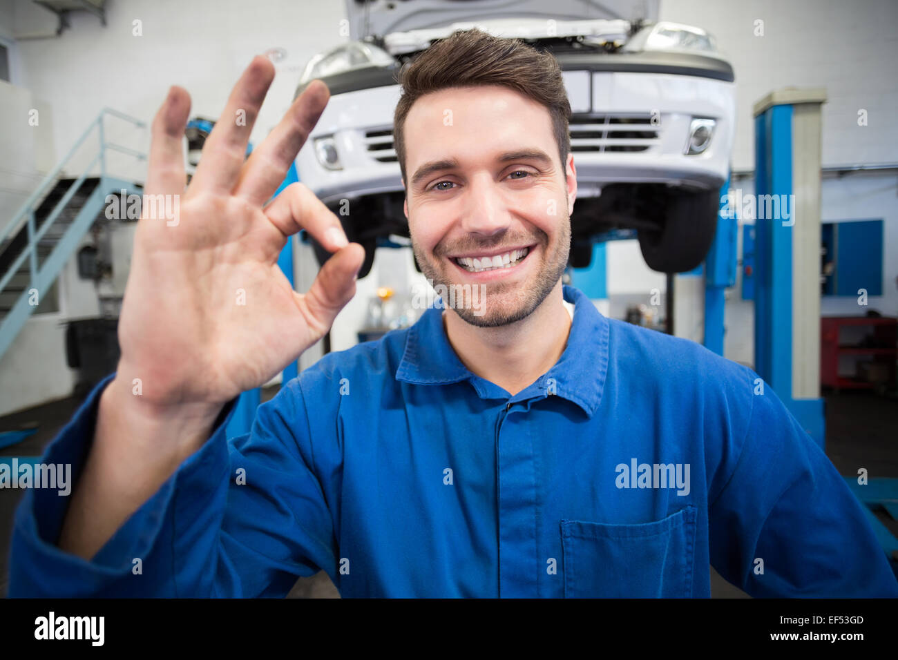 Mechanic smiling at the camera Stock Photo - Alamy