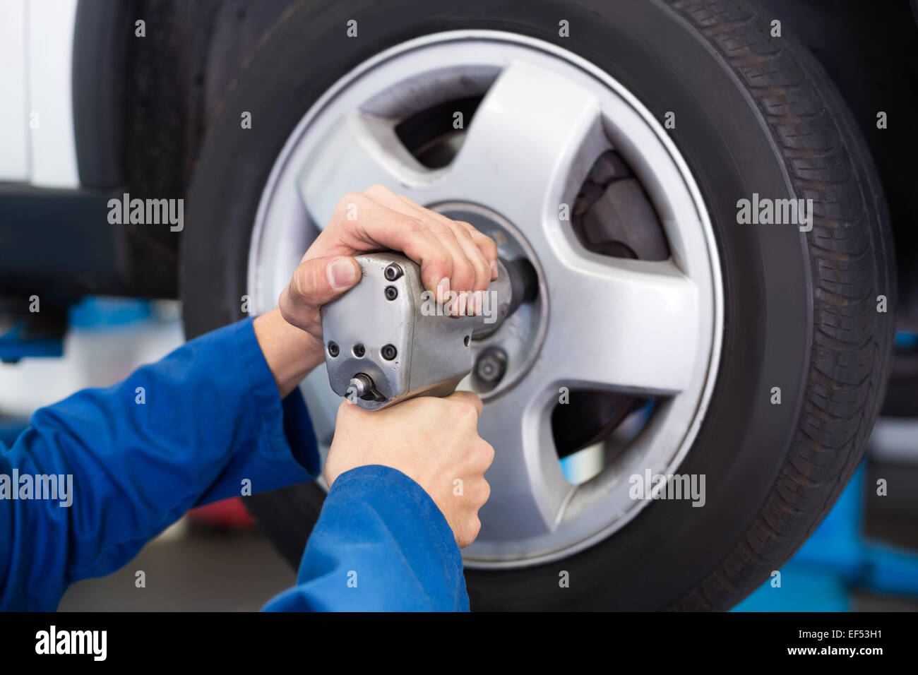 Mechanic adjusting the tire wheel Stock Photo - Alamy