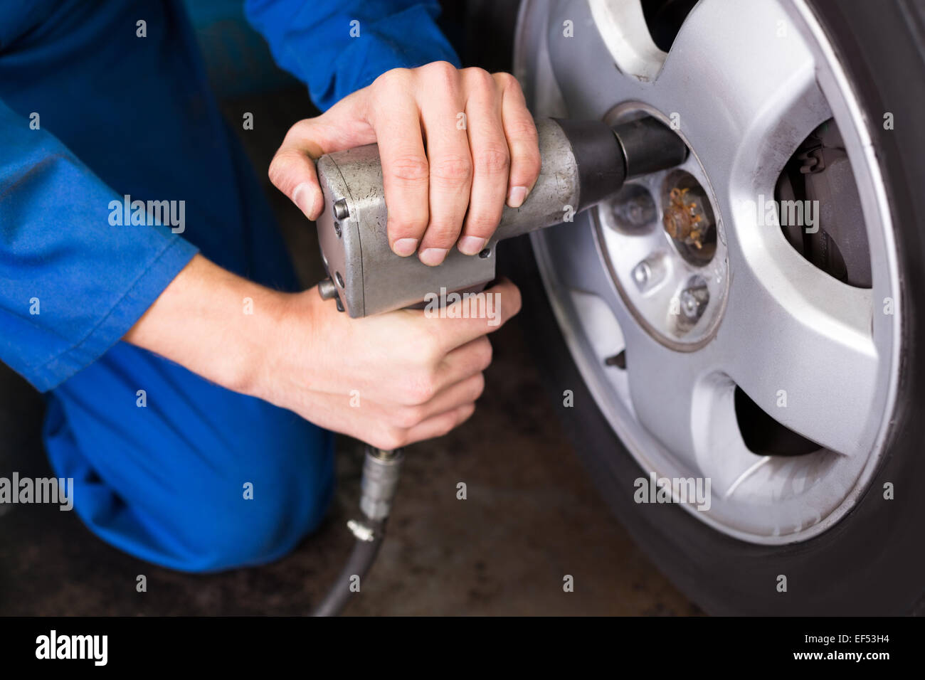 Mechanic adjusting the tire wheel Stock Photo - Alamy