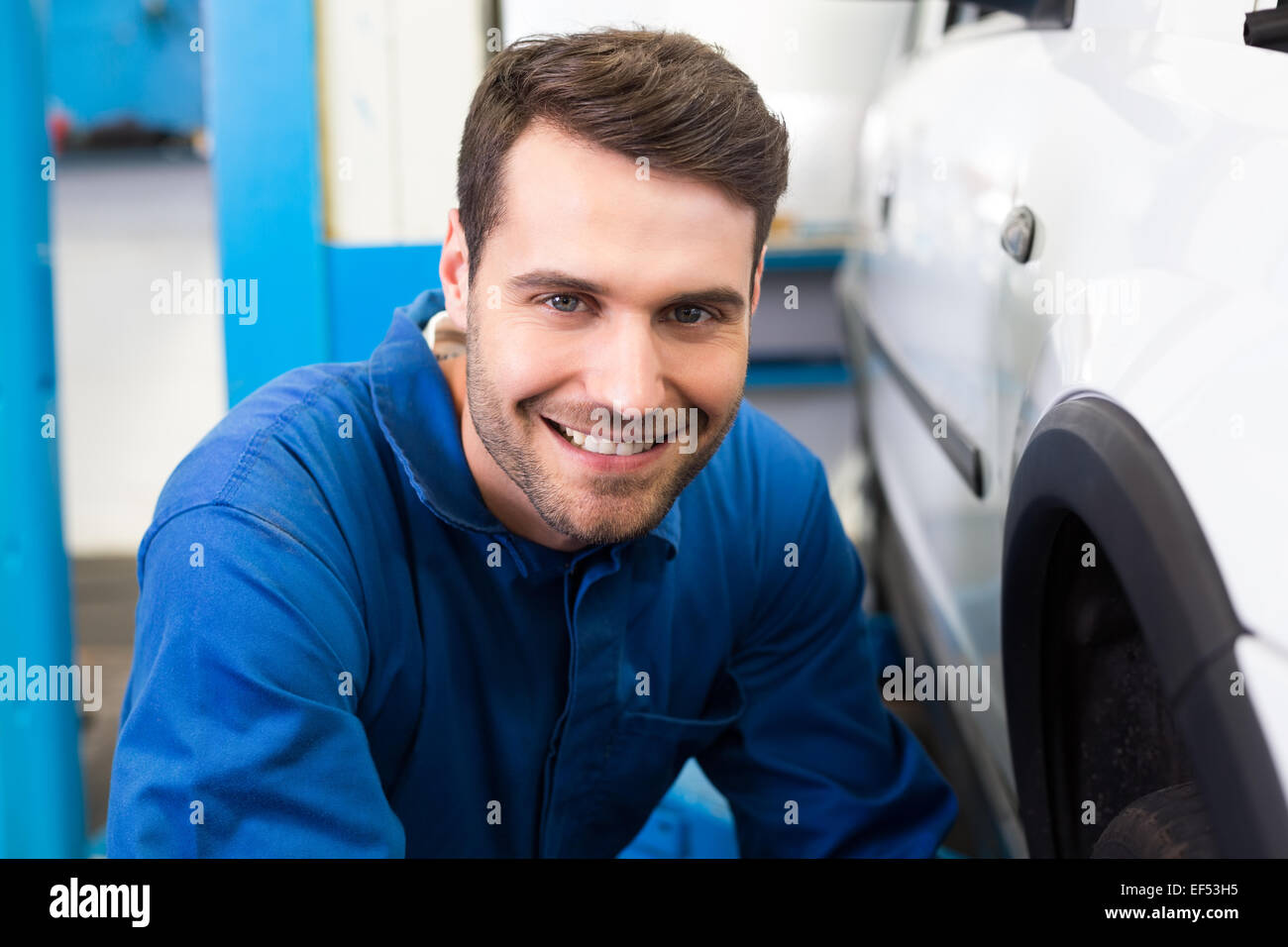 Mechanic smiling at the camera Stock Photo - Alamy
