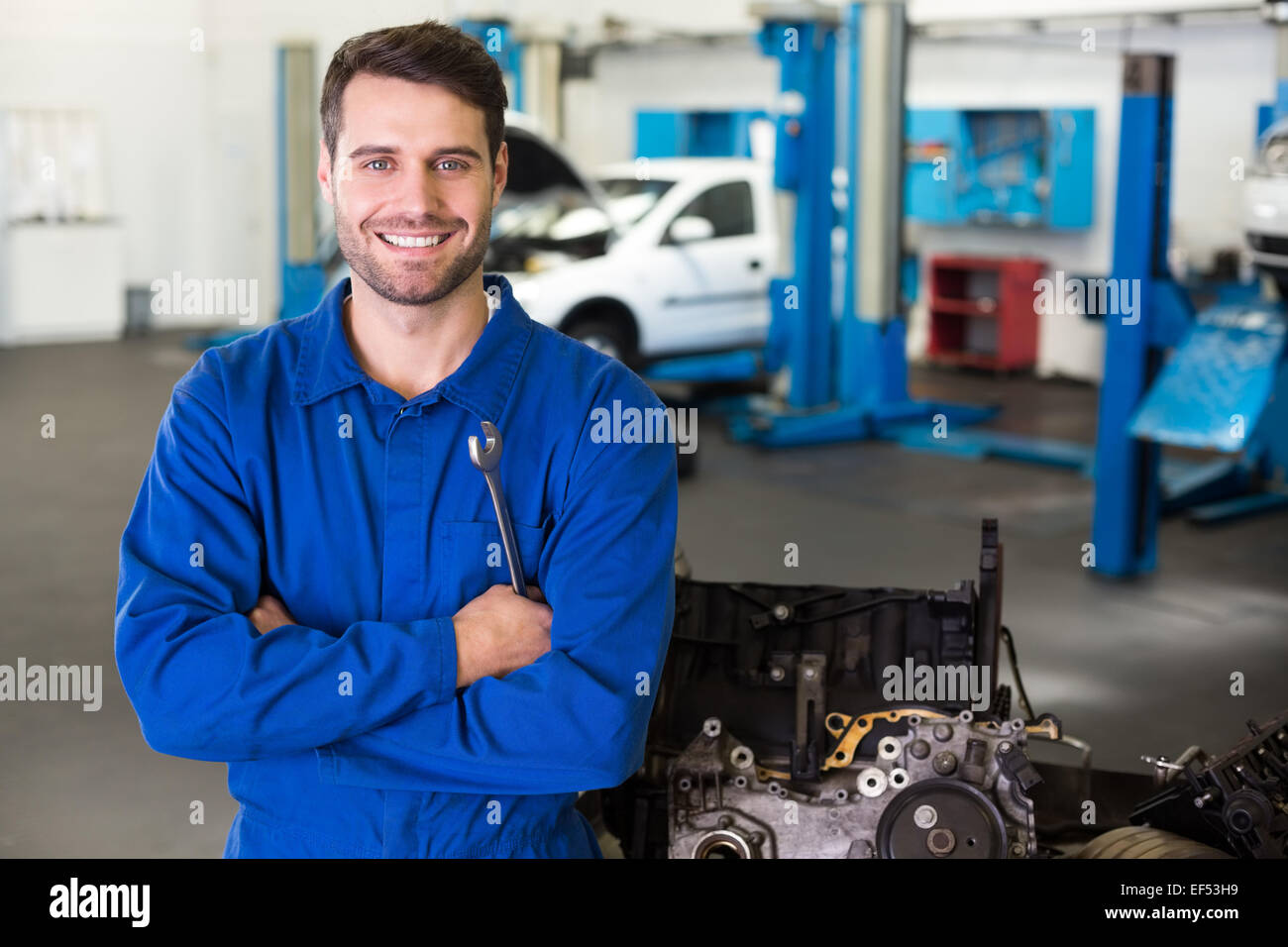 Mechanic smiling at the camera Stock Photo - Alamy