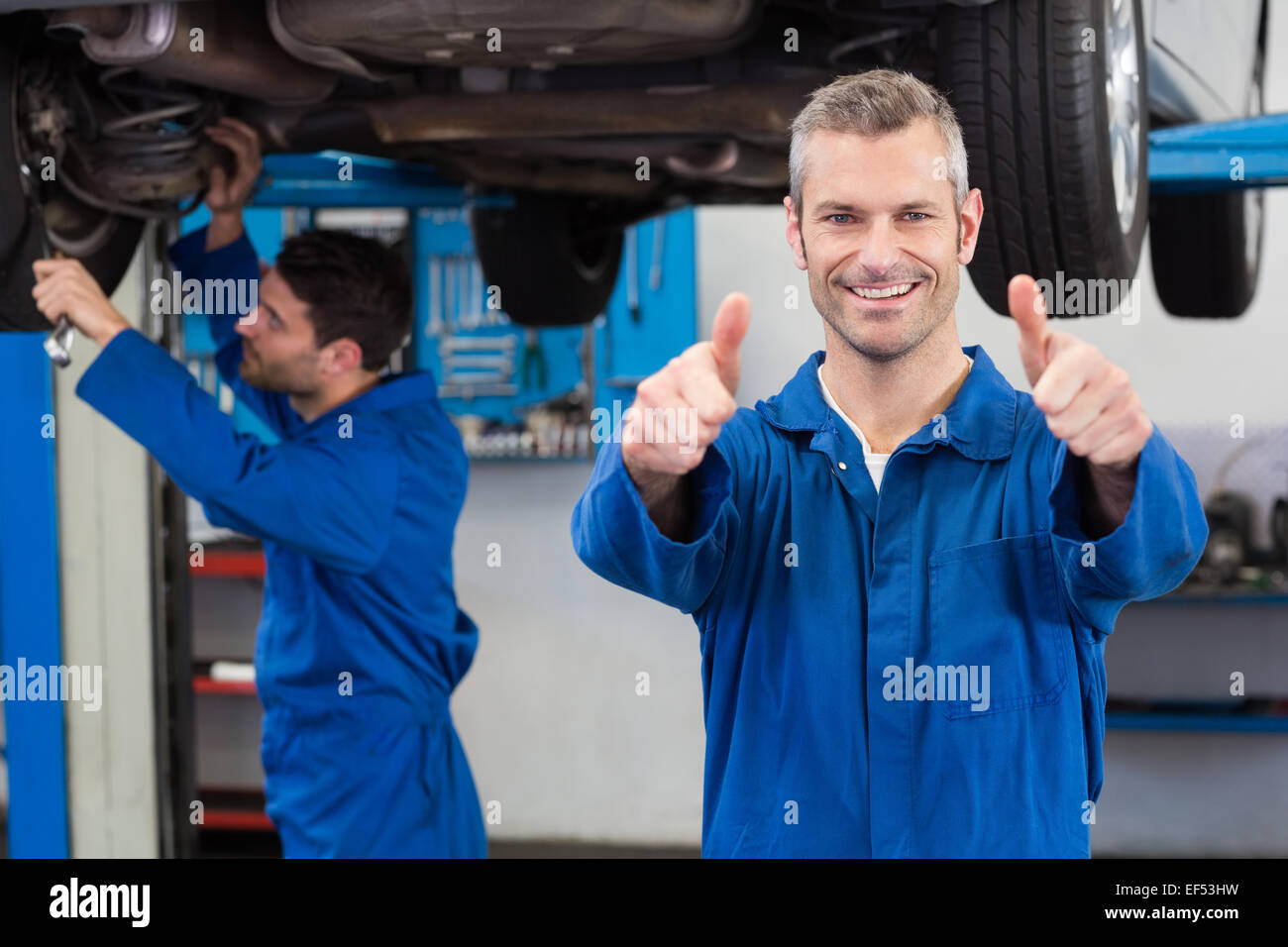 Team of mechanics working together Stock Photo - Alamy
