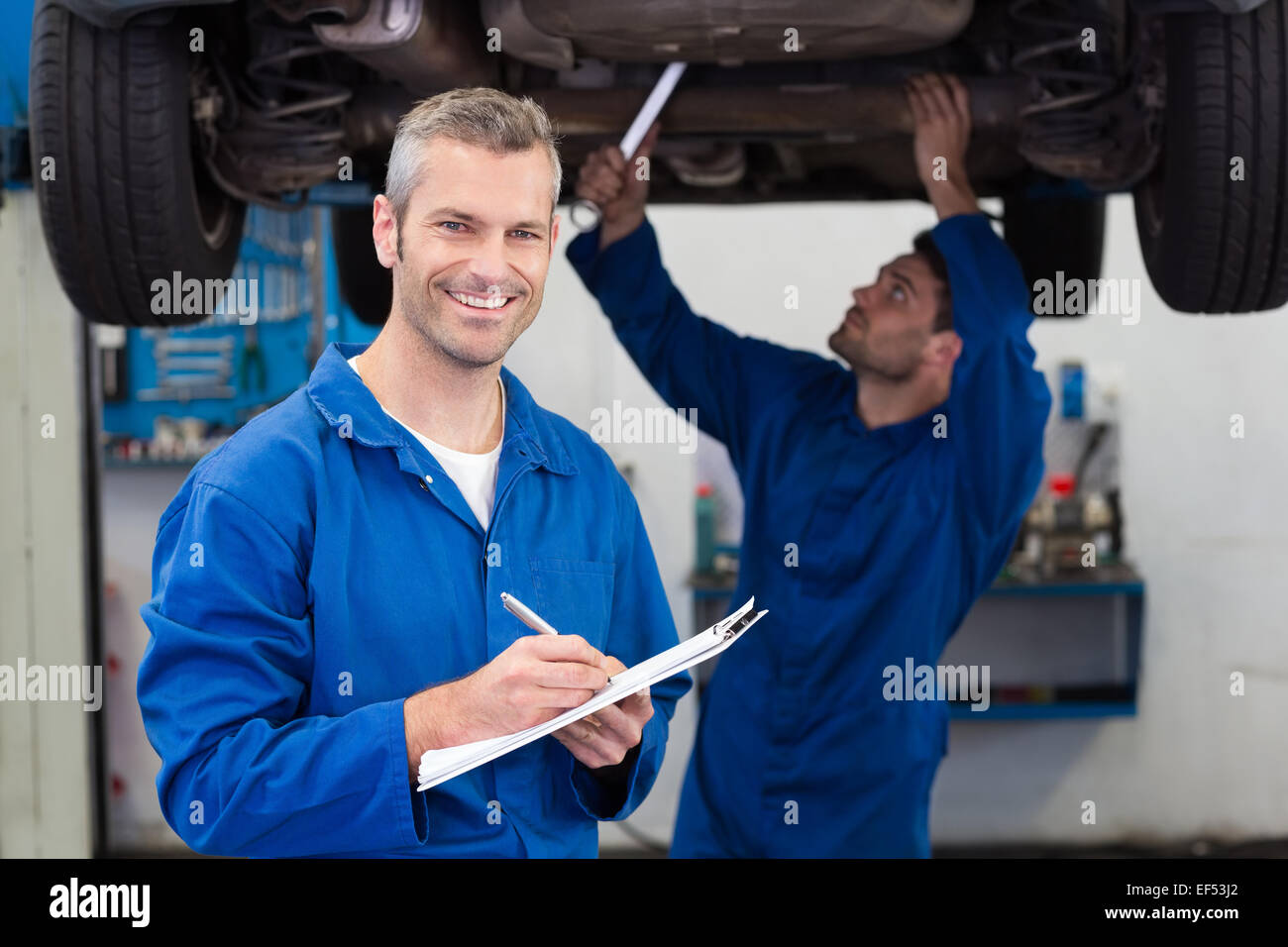 Car mechanic working team fixing hi-res stock photography and images ...