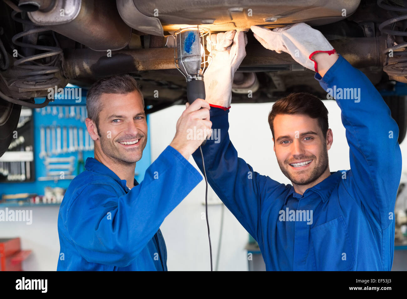 Team of mechanics working together Stock Photo - Alamy