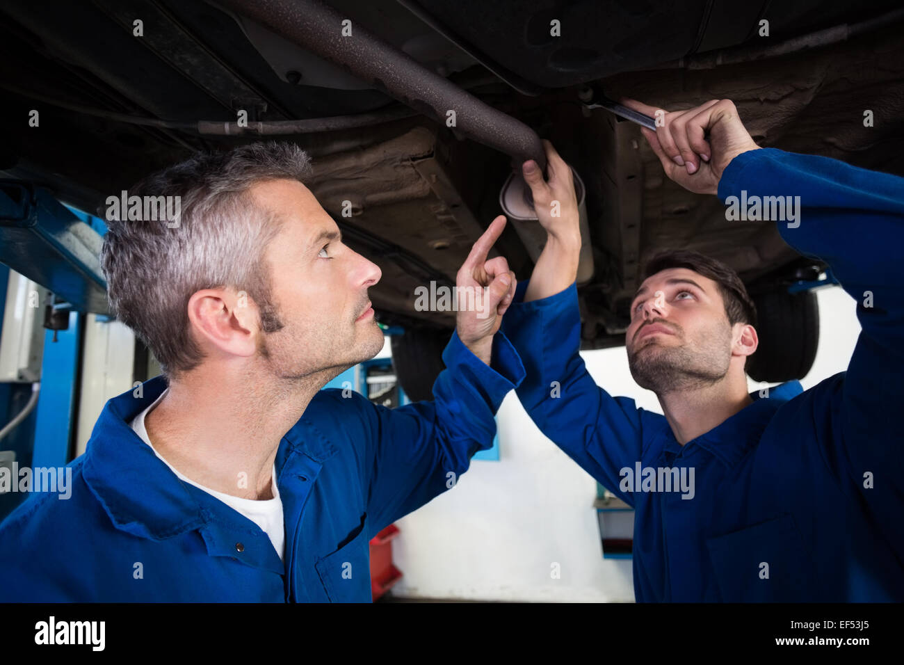 Team of mechanics working together Stock Photo - Alamy