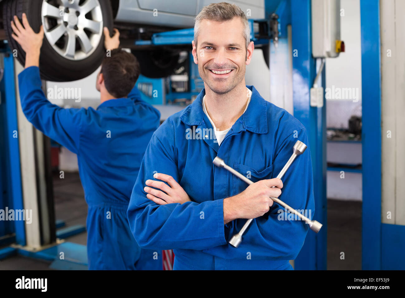 Mechanic smiling at the camera Stock Photo - Alamy