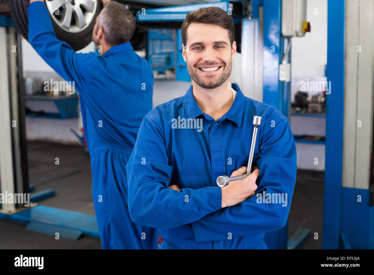 Mechanic smiling at the camera Stock Photo - Alamy