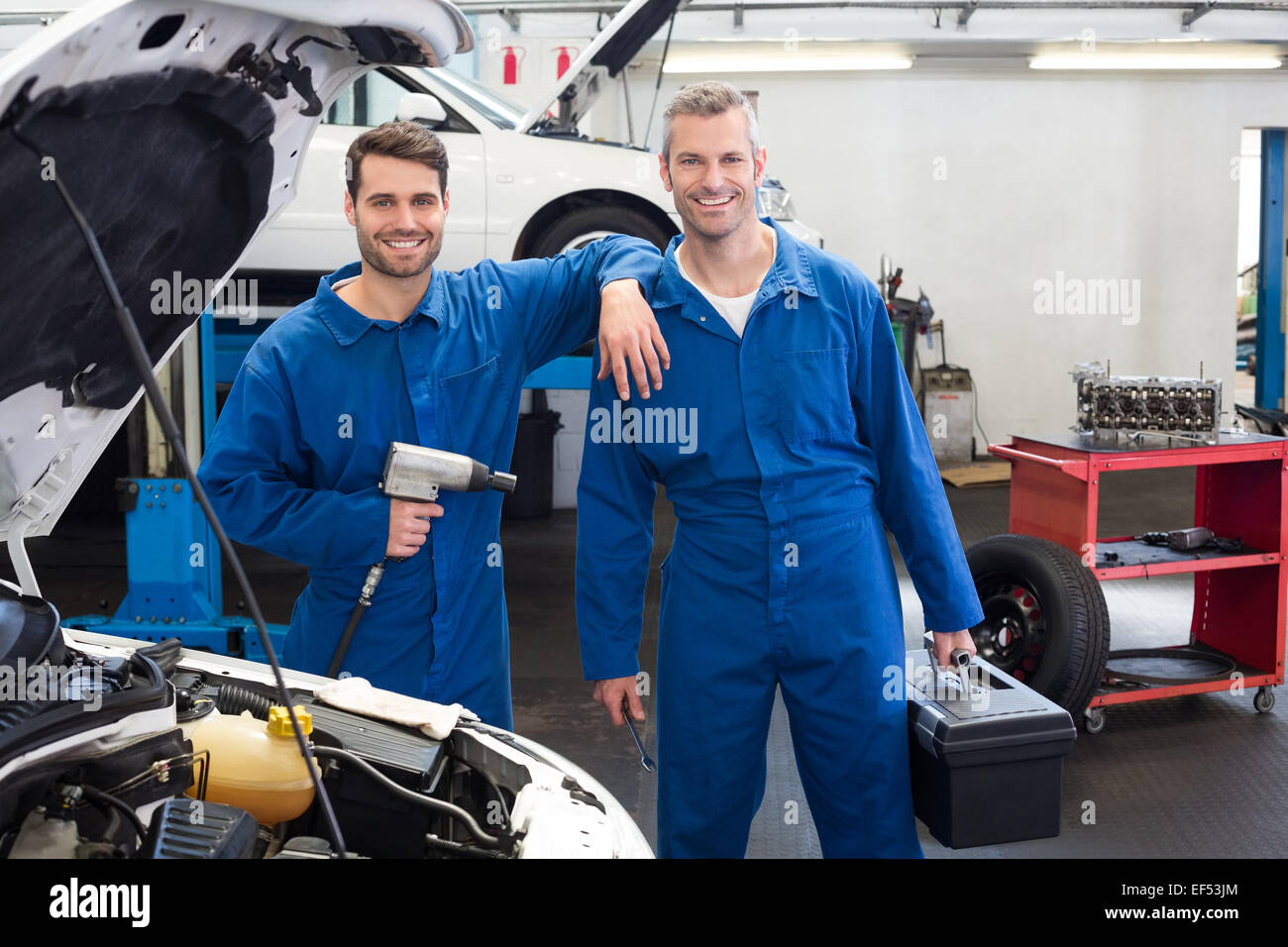 Team of mechanics working together Stock Photo - Alamy