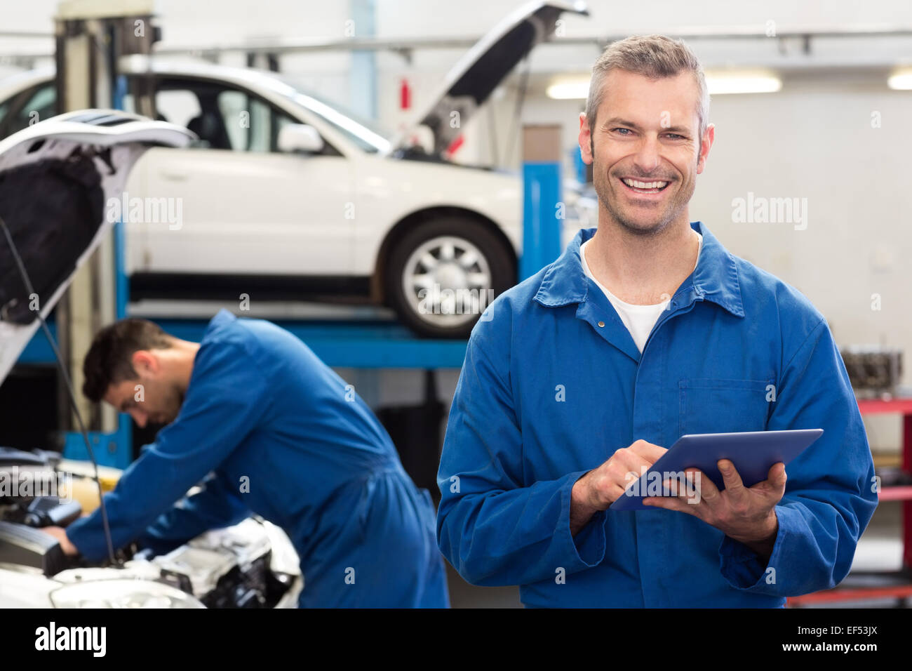 Mechanic tablet pc repairing car hi-res stock photography and images ...
