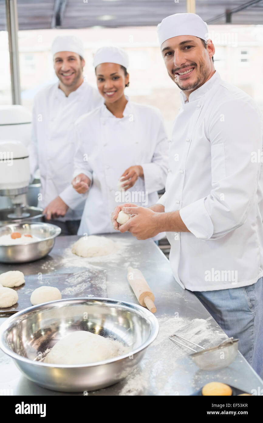 Team of bakers working at counter Stock Photo - Alamy