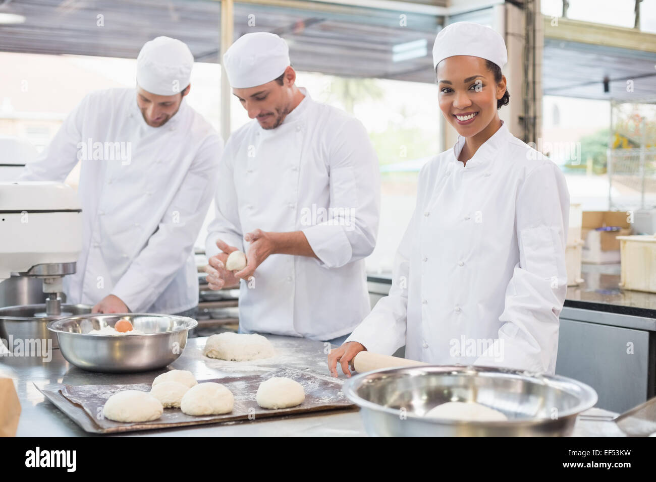 Team of bakers working at counter Stock Photo - Alamy