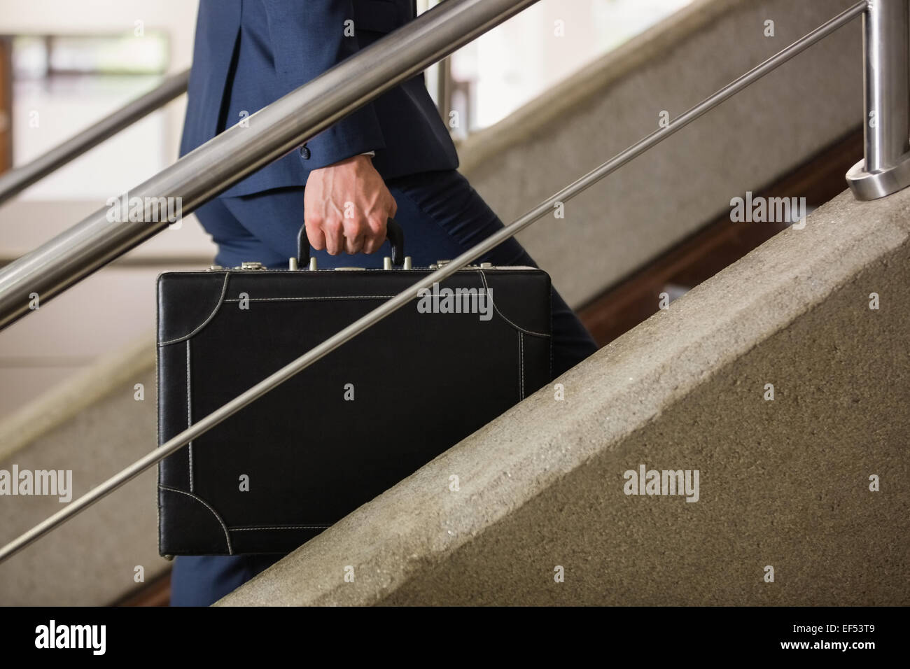 Businessman climbing up the stairs Stock Photo - Alamy