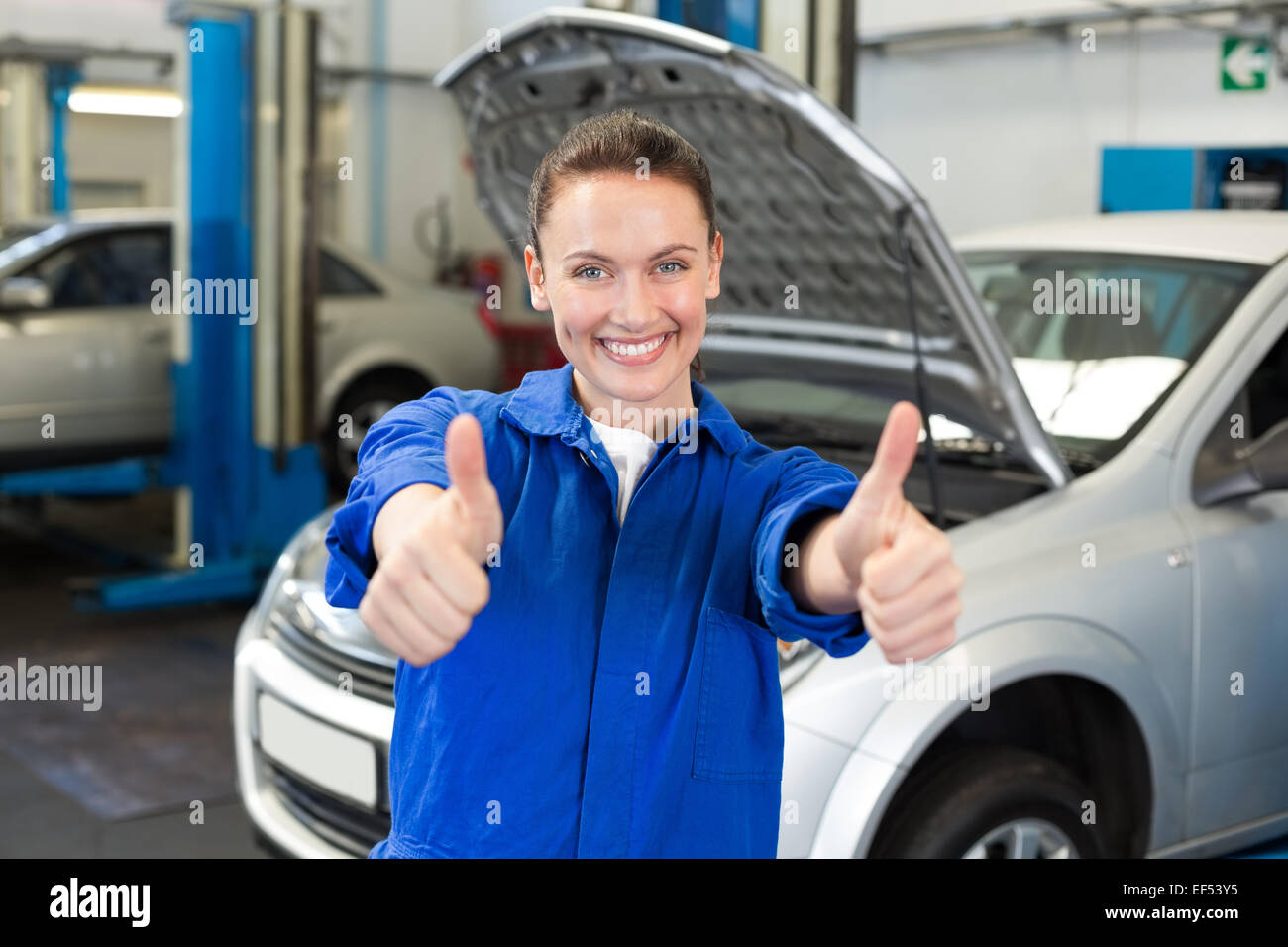 Mechanic smiling at the camera Stock Photo - Alamy