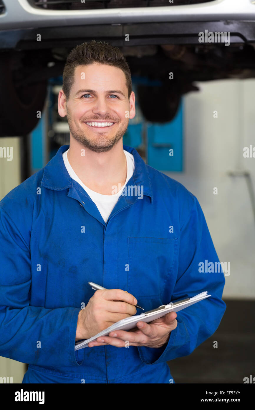 Mechanic smiling at the camera Stock Photo - Alamy