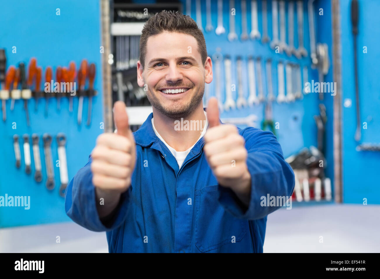 Smiling mechanic looking at camera Stock Photo - Alamy