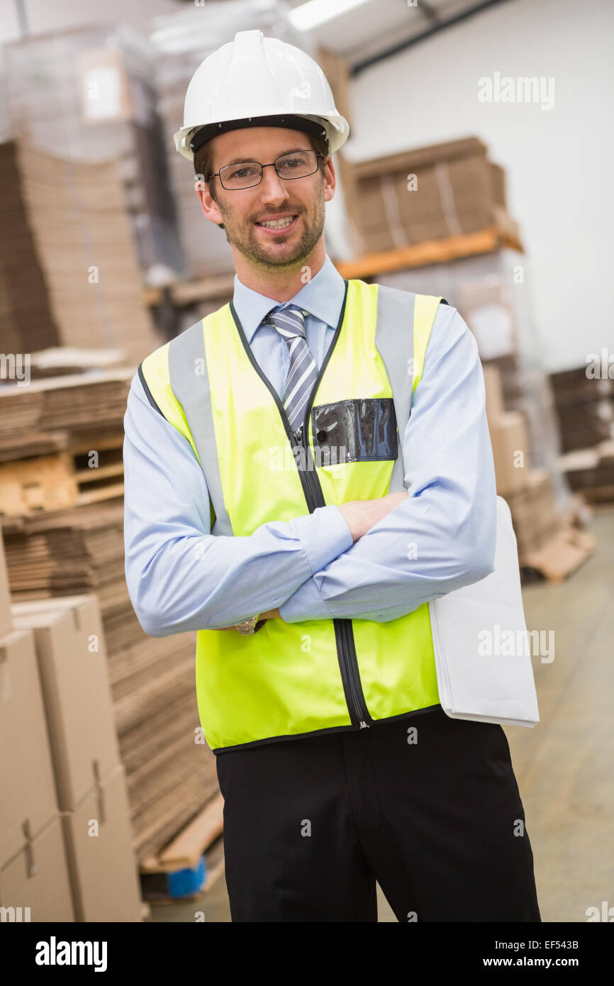 Worker wearing hard hat in warehouse Stock Photo - Alamy