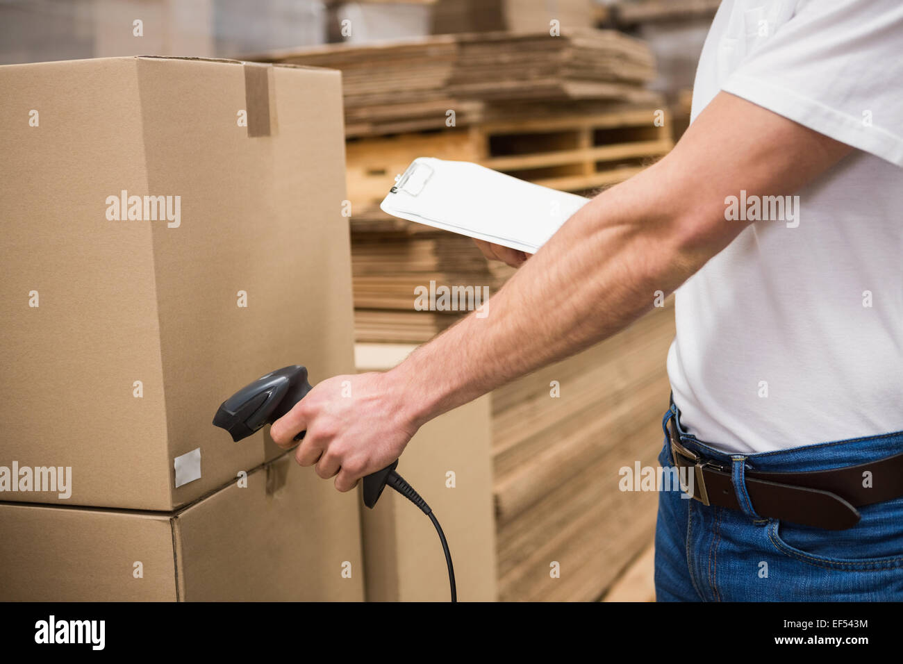 Worker using scanner in warehouse Stock Photo - Alamy
