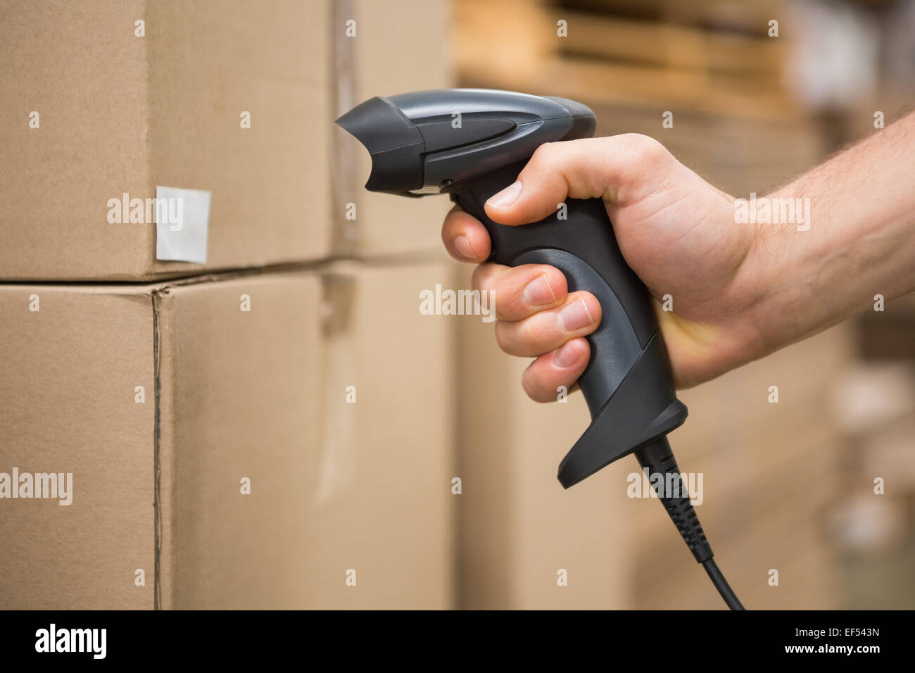 Worker holding scanner in warehouse Stock Photo - Alamy