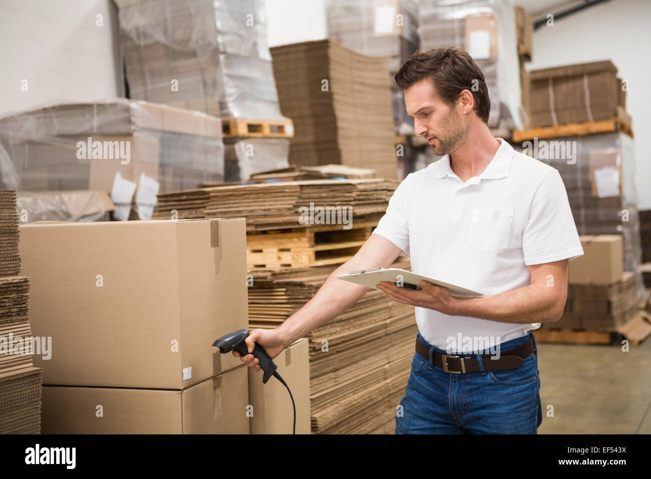 Worker scanning package in warehouse Stock Photo - Alamy
