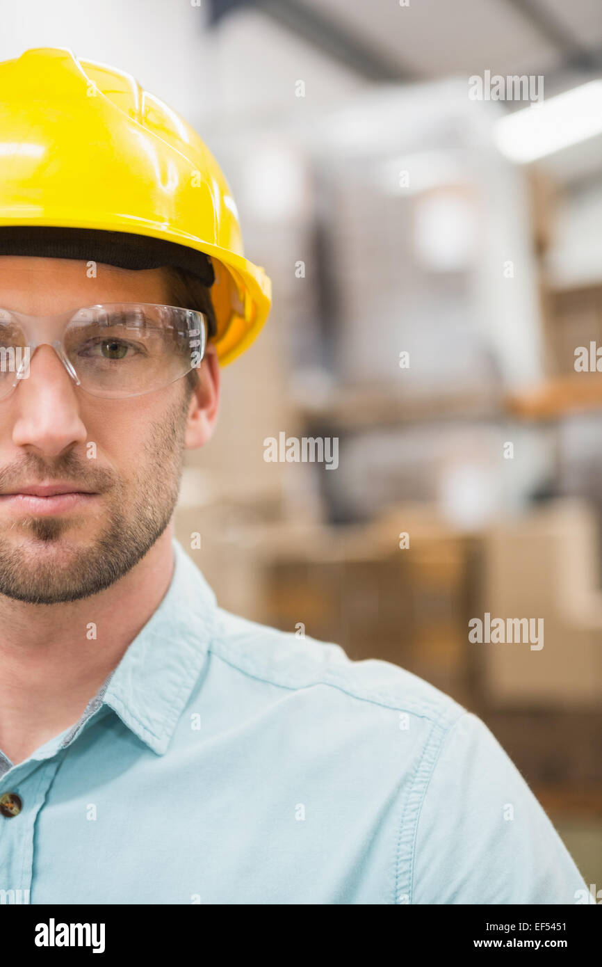 Close up of worker wearing hard hat in warehouse Stock Photo - Alamy