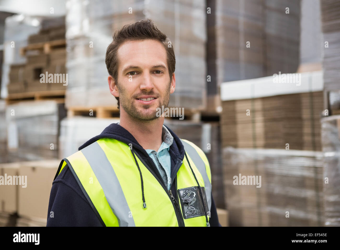 Warehouse worker smiling at camera Stock Photo - Alamy