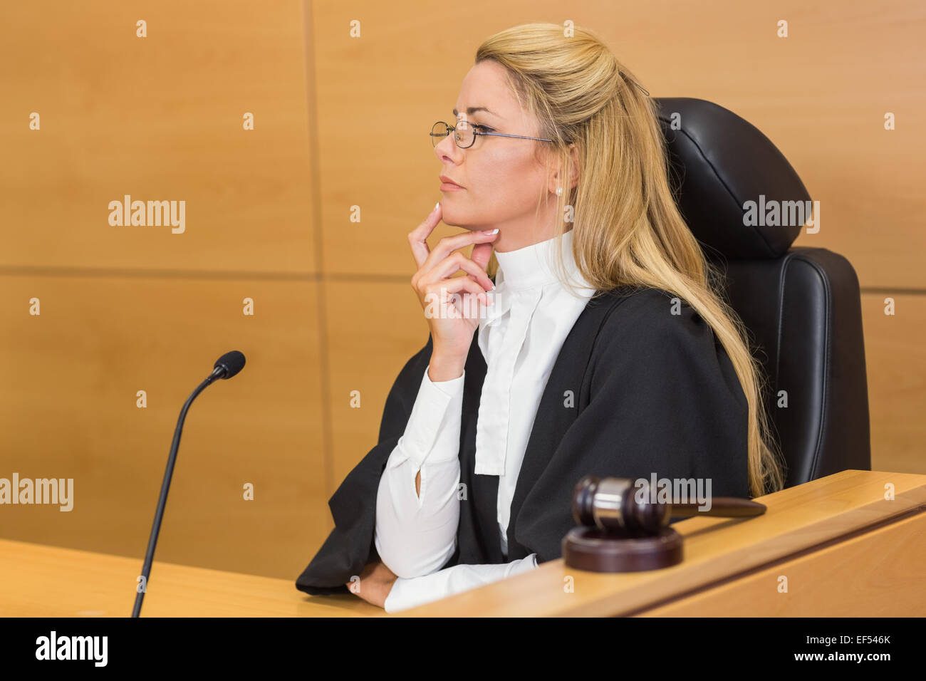 Stern judge looking and listening Stock Photo - Alamy