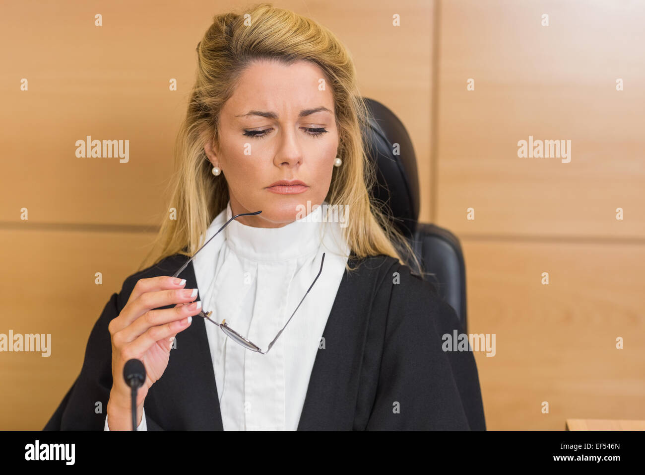Stern judge looking and listening Stock Photo - Alamy