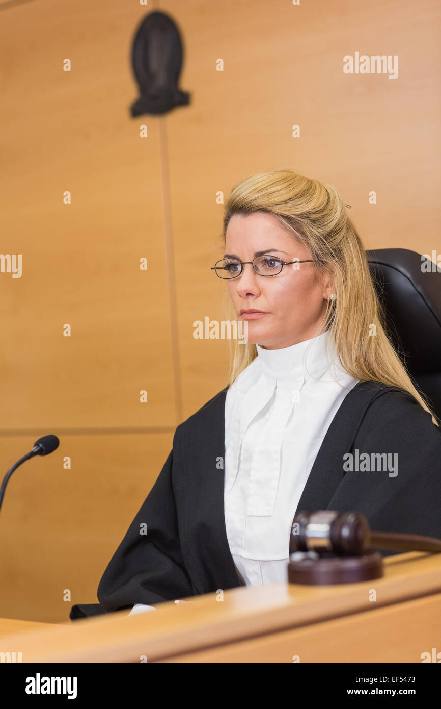 Stern judge sitting and listening Stock Photo - Alamy