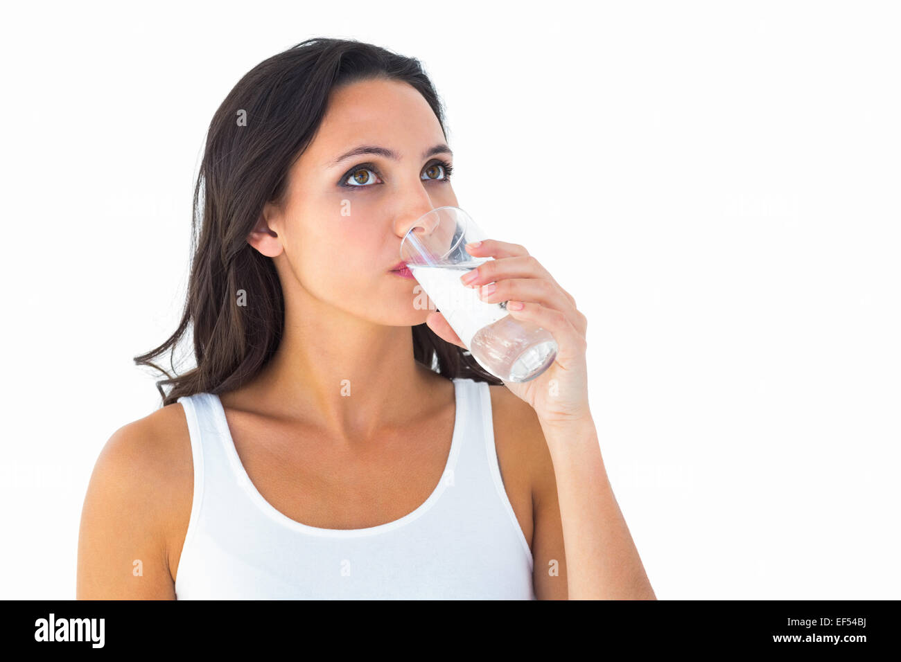 Pretty brunette drinking glass of water Stock Photo - Alamy