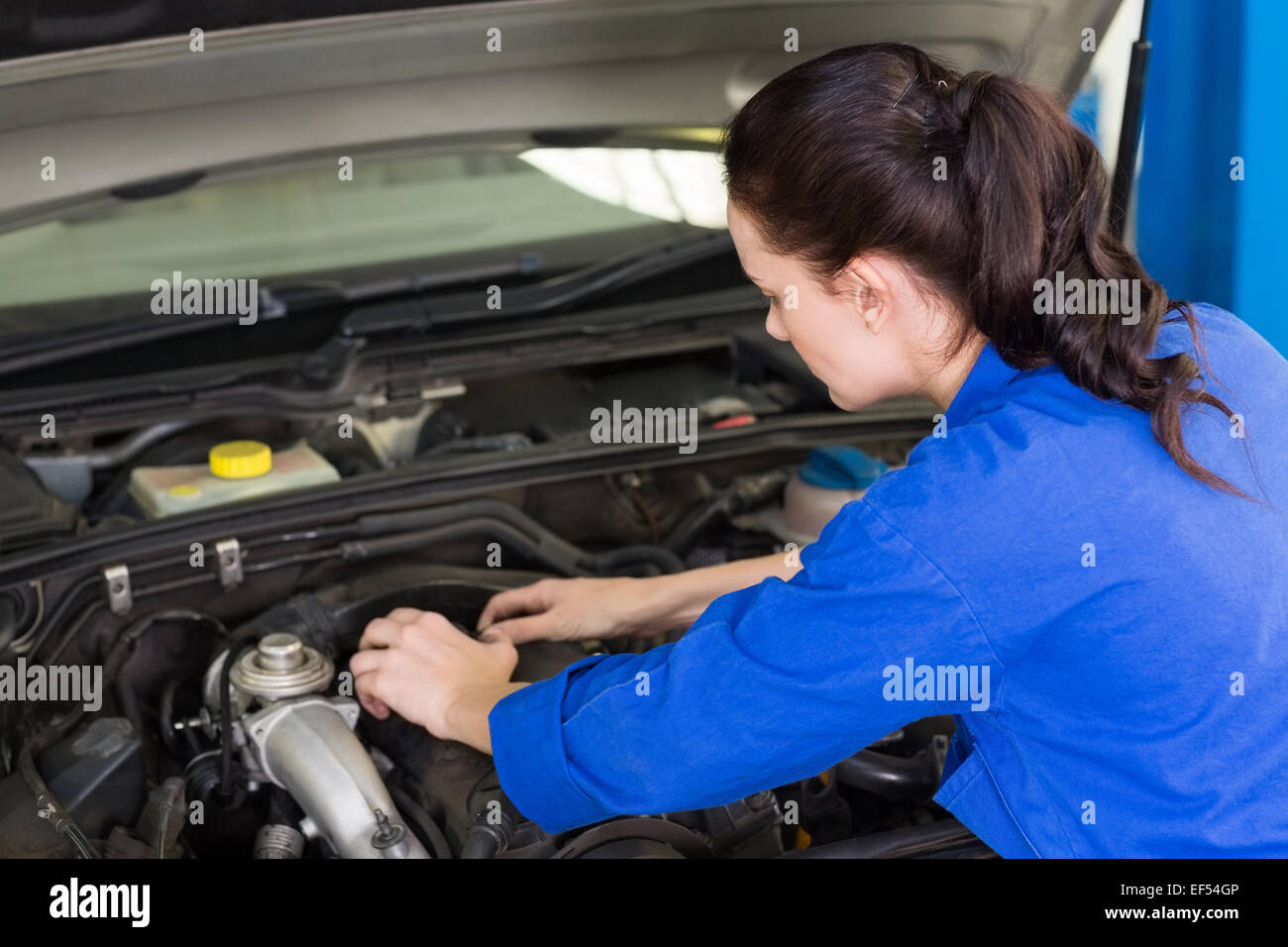 Mechanic working under the hood Stock Photo - Alamy