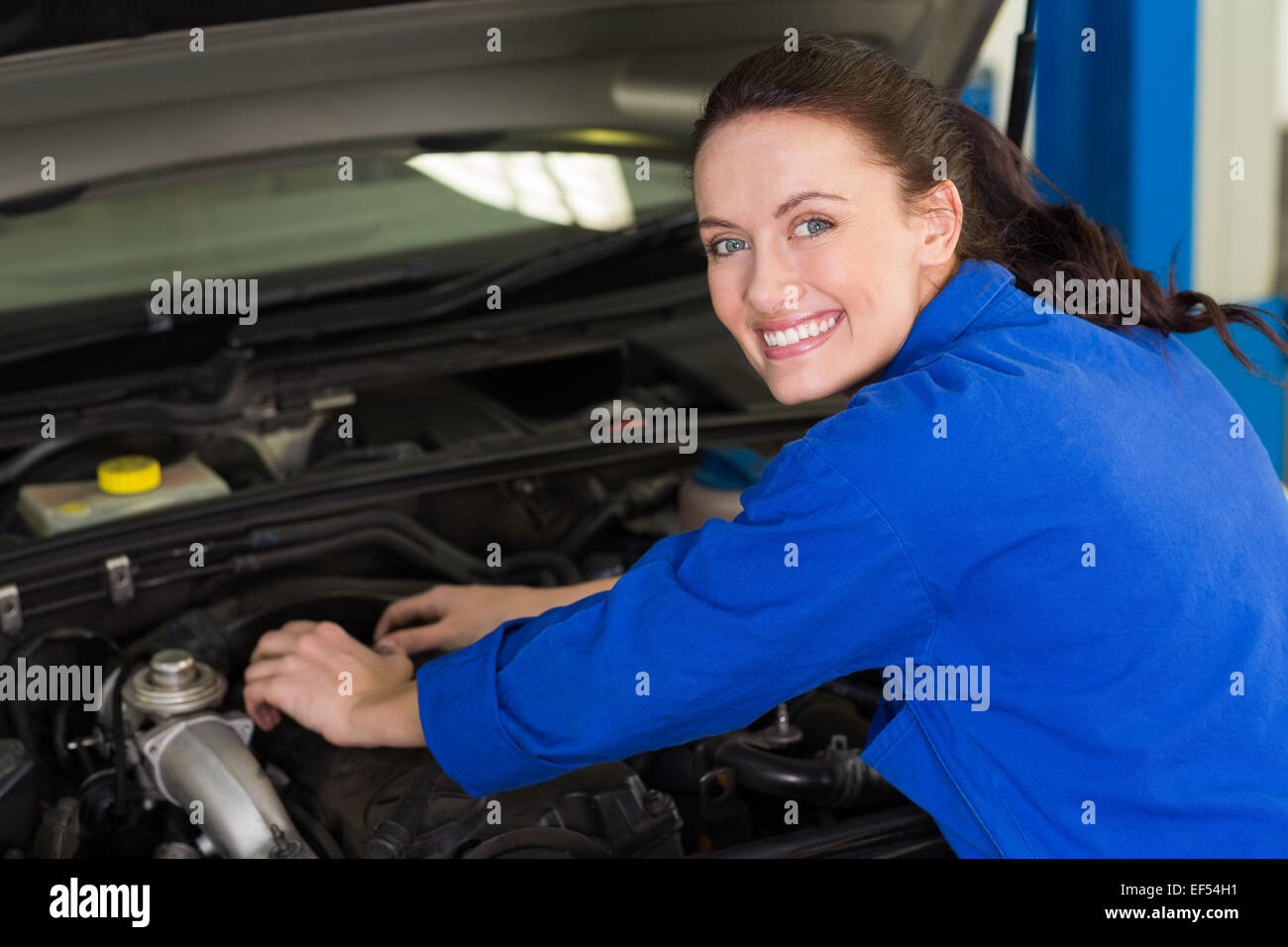 Mechanic working under the hood Stock Photo - Alamy