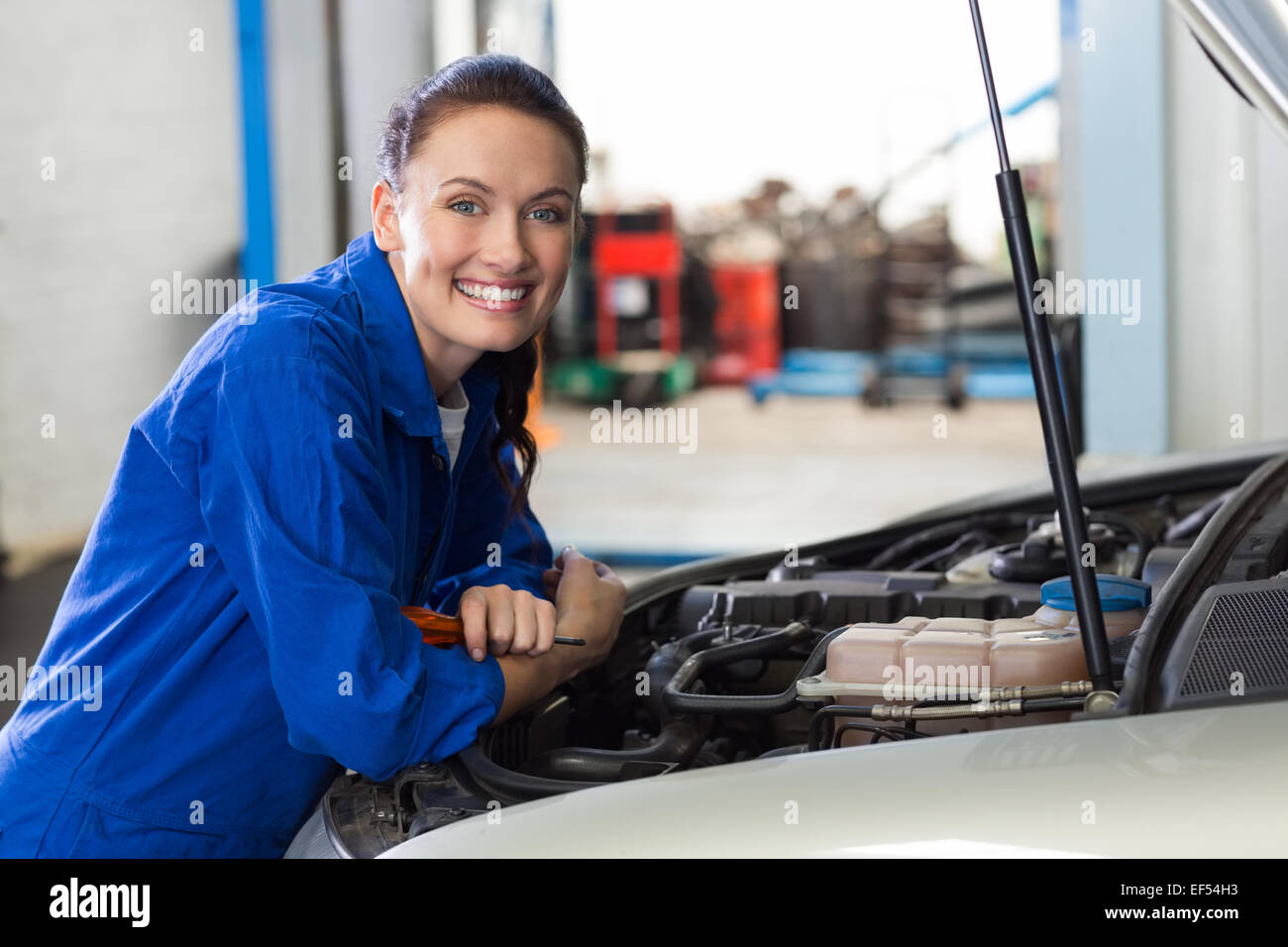 Mechanic smiling at the camera Stock Photo - Alamy