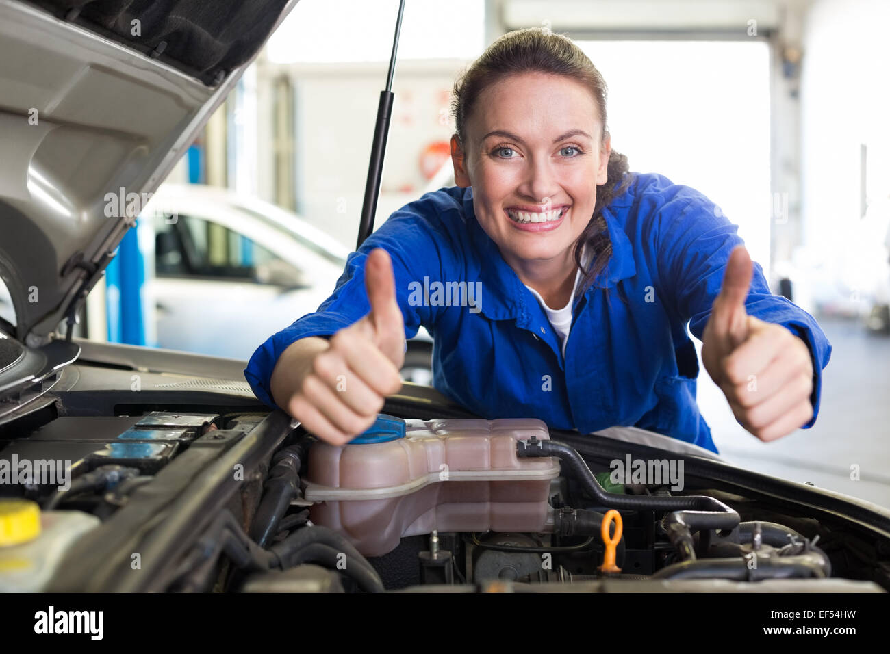 Mechanic smiling at the camera Stock Photo - Alamy