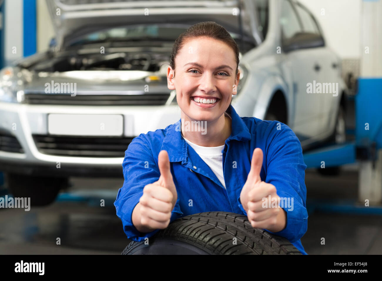 Mechanic smiling at the camera Stock Photo - Alamy
