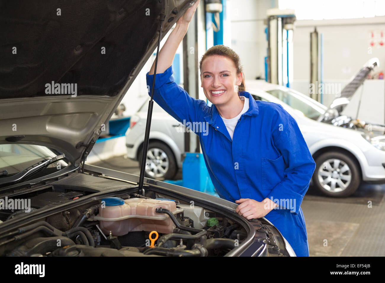 Mechanic smiling at the camera Stock Photo - Alamy