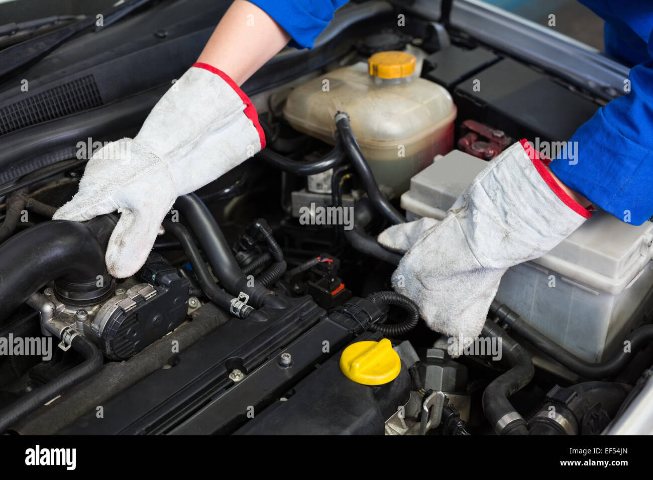 Mechanic working under the hood Stock Photo - Alamy