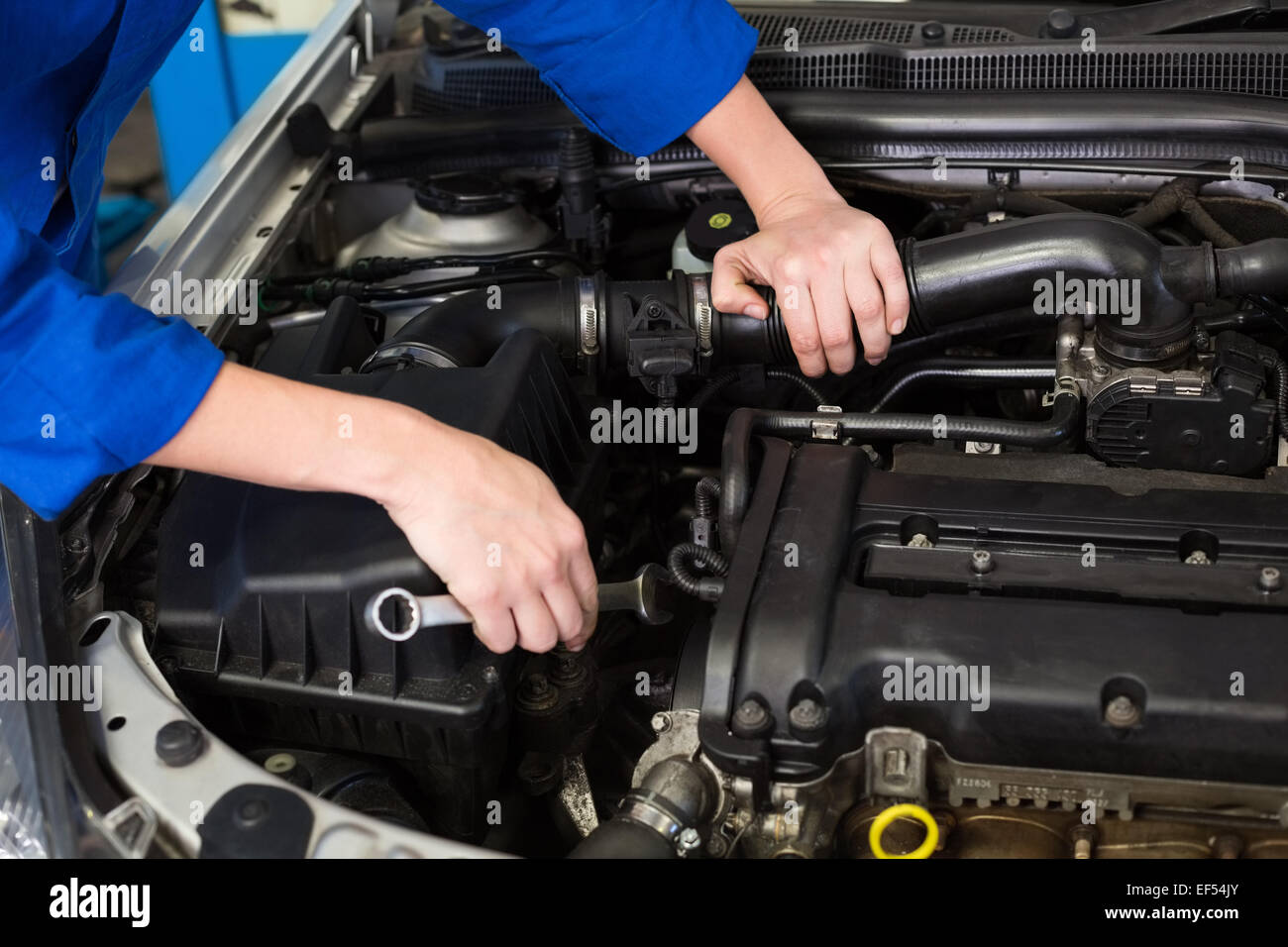 Mechanic working on an engine Stock Photo - Alamy