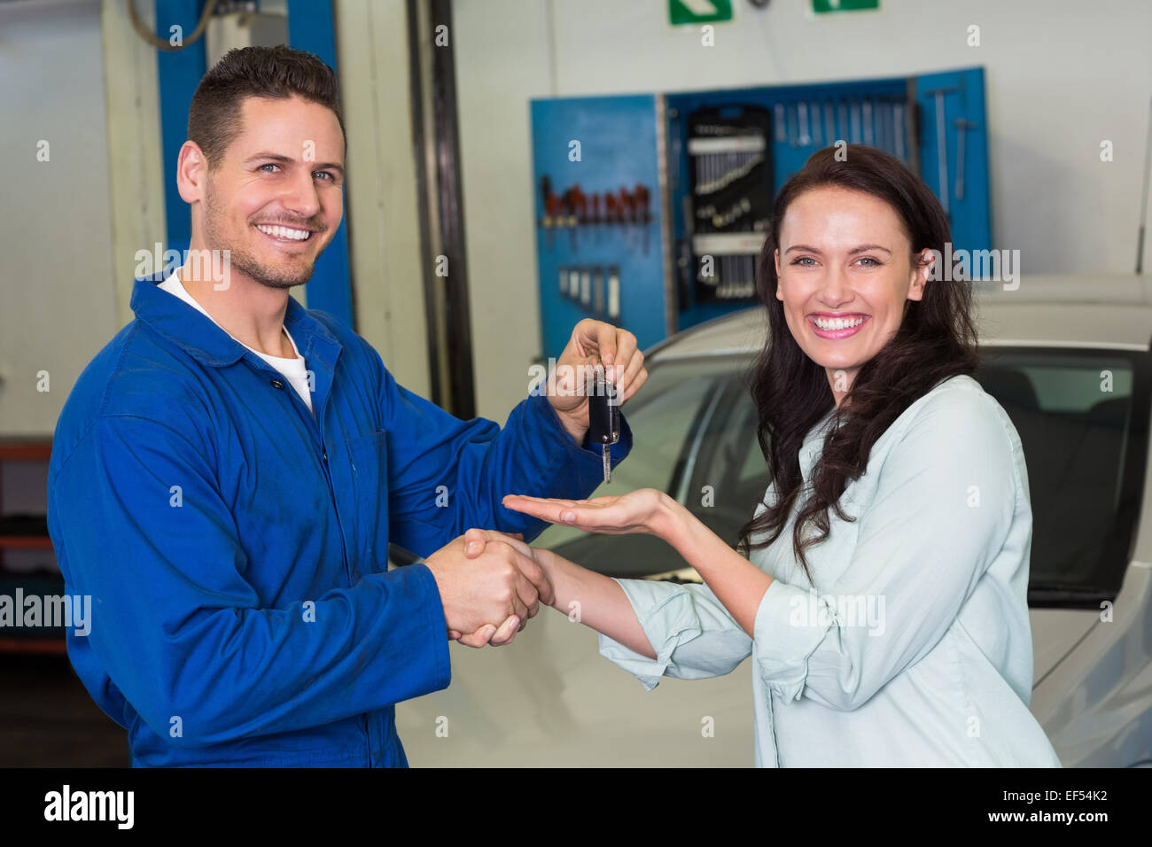 Mechanic man giving key customer hi-res stock photography and images ...
