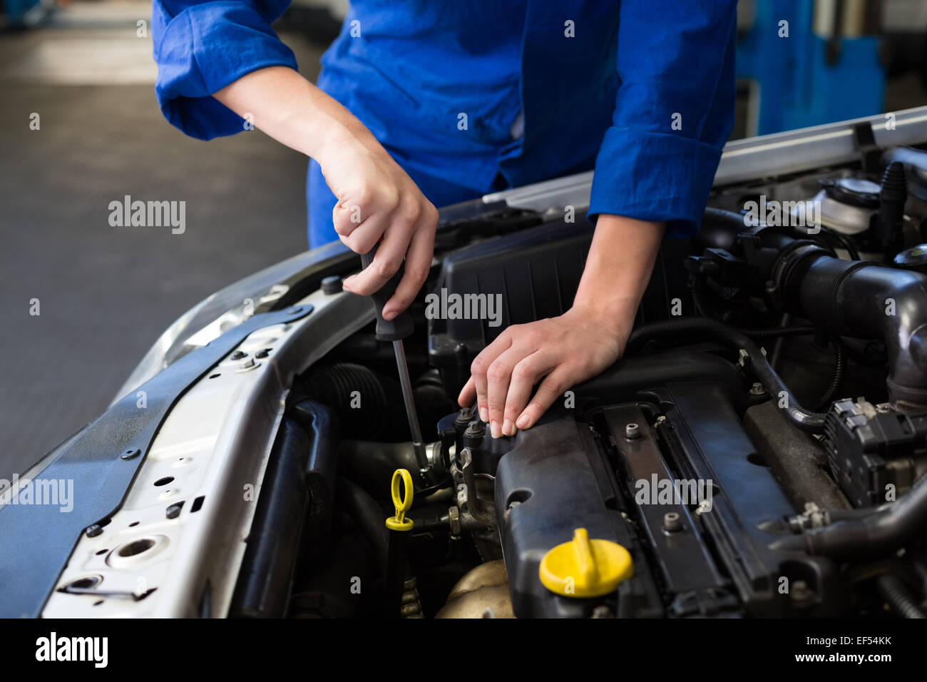Mechanic working under the hood Stock Photo - Alamy
