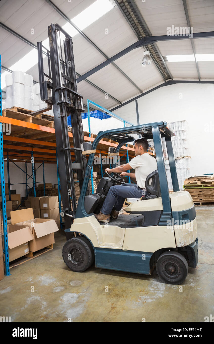 Forklift machine in a large warehouse Stock Photo - Alamy